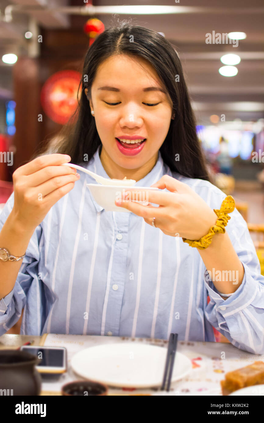 Happy asian woman enjoying Chinese food in Chinese restaurant Stock ...