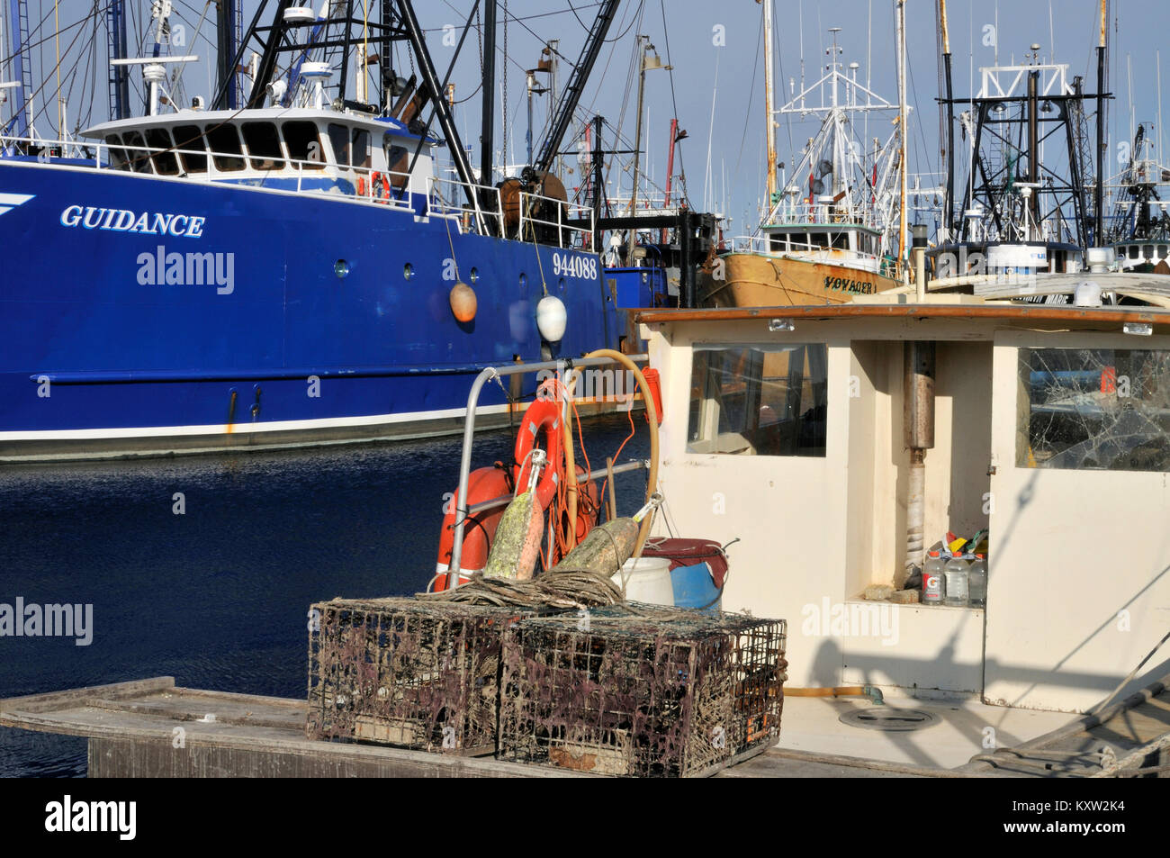 Close-up of steel hulled fishing trawlers tied to wharf in background ...