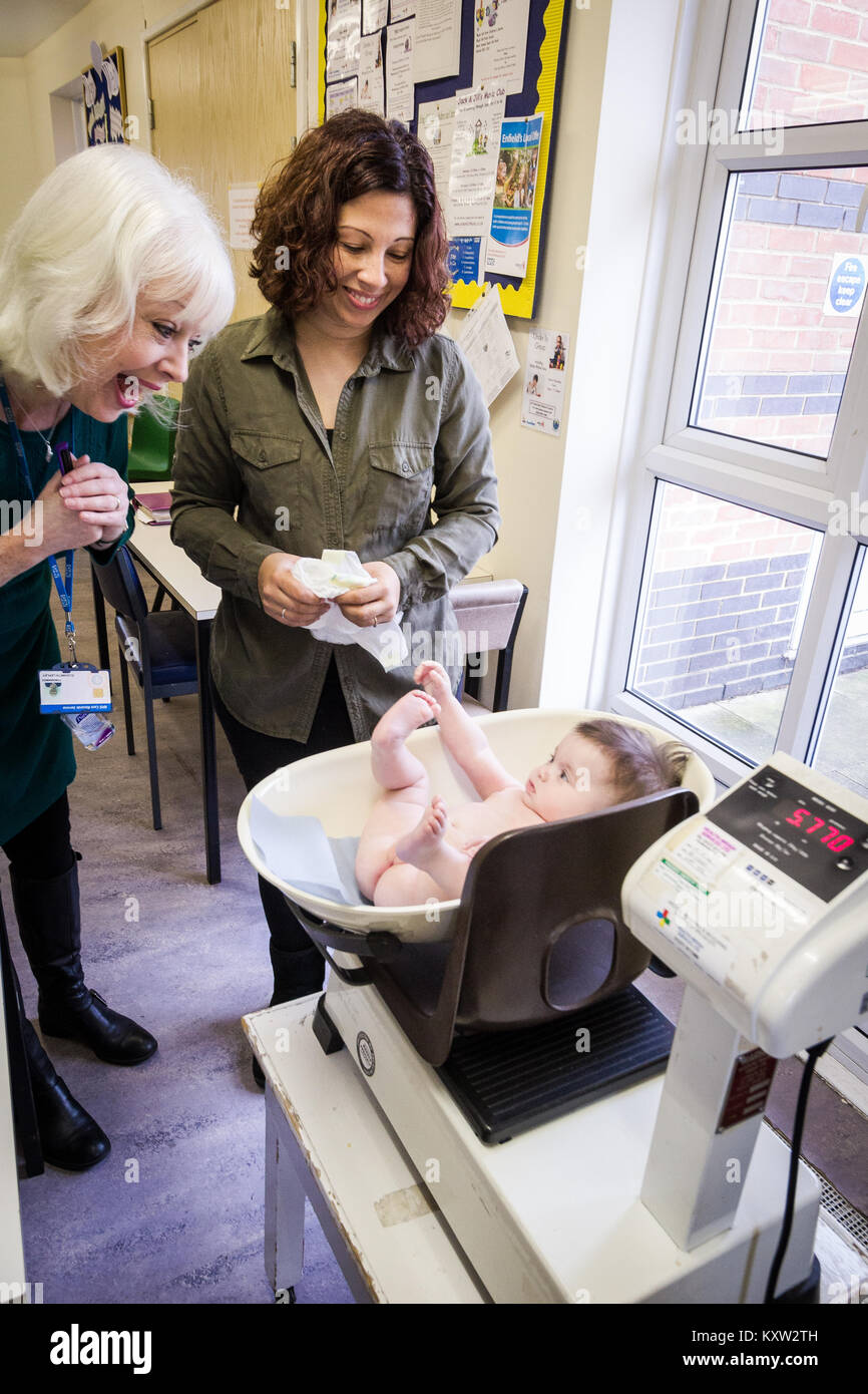Baby weighing mother scales hi-res stock photography and images - Alamy