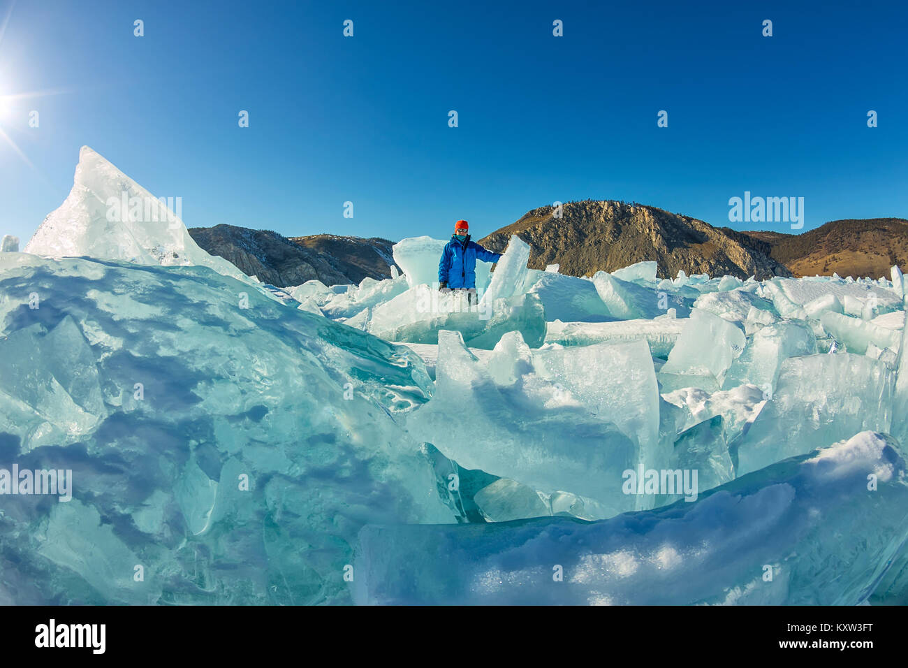 girl stands among the large blue ice ridges of Lake Baikal Stock Photo ...