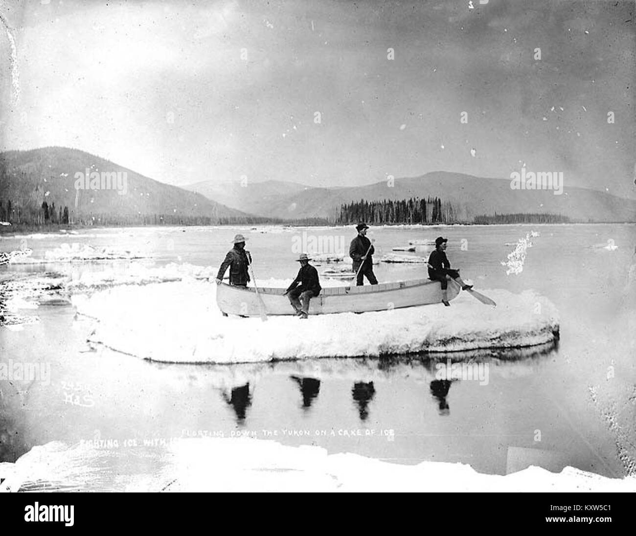 A circa 1898 photograph by Eric A. Hegg showing four men in a canoe ...