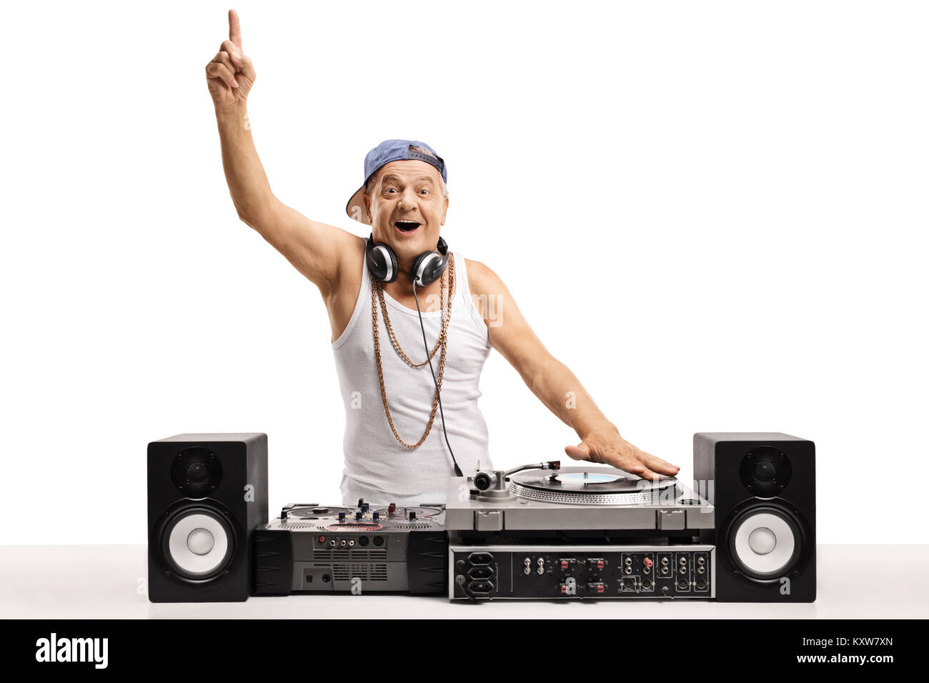 Cheerful old DJ playing music on a turntable and holding his finger up ...