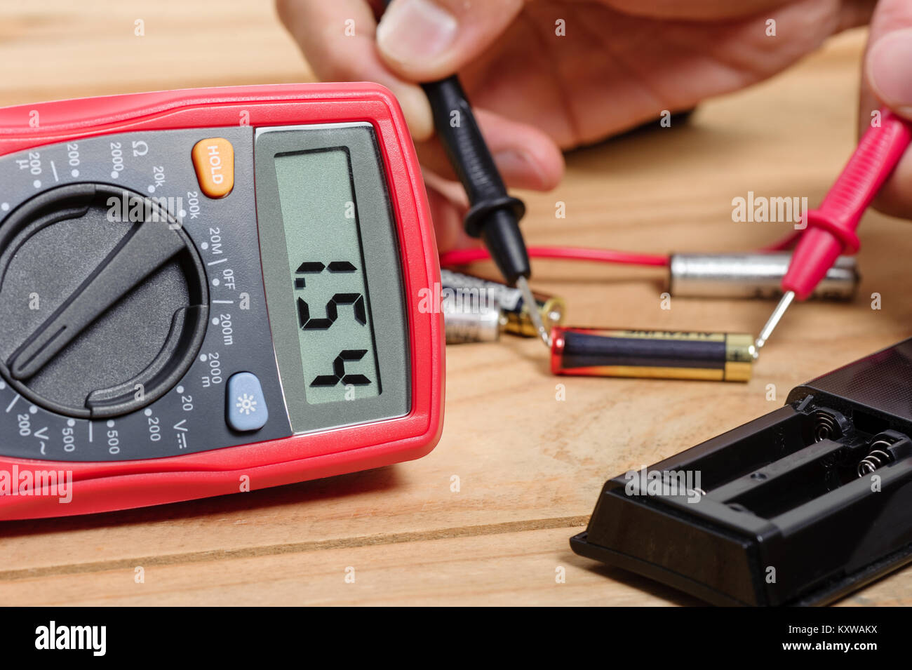electrician using the digital multimeter to check the battery Stock ...