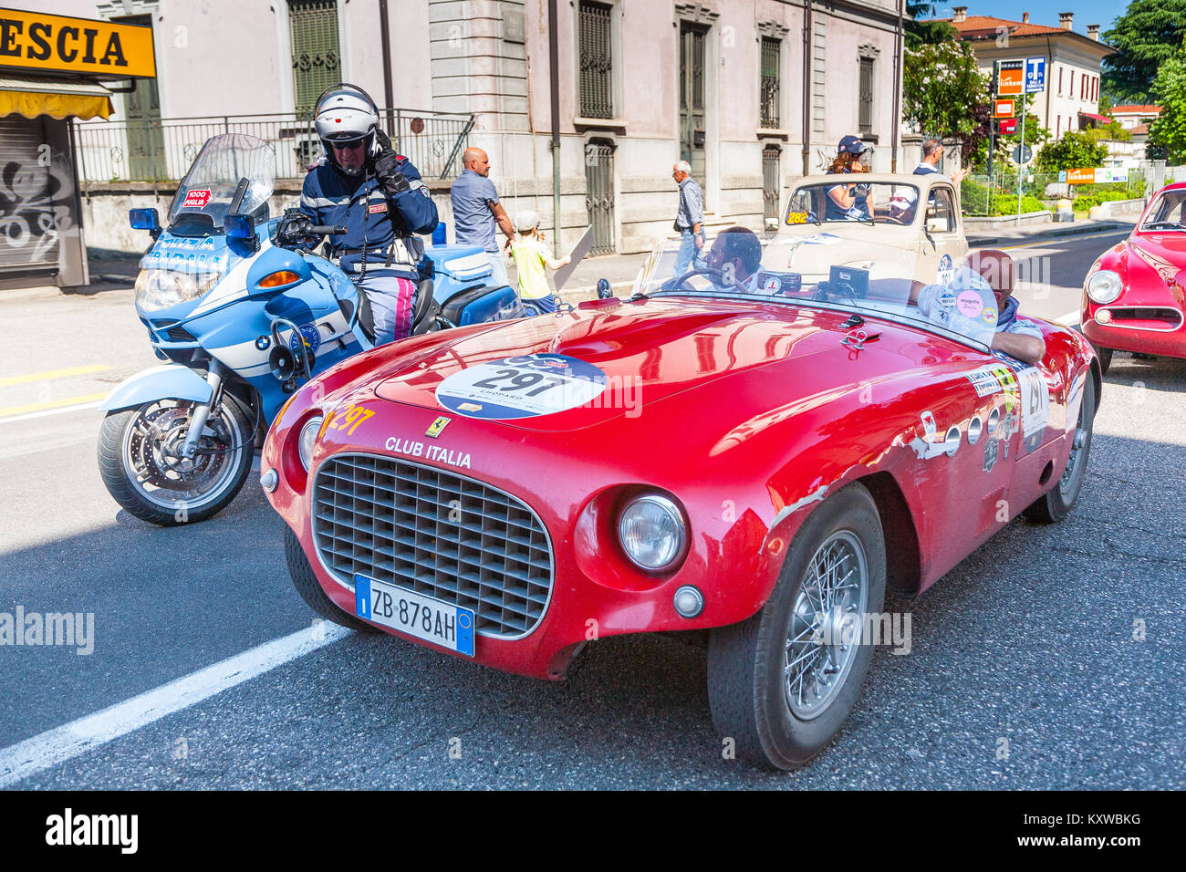 A police motorbike rider alongside a 1953 FERRARI 250 MM SPIDER VIGNALE ...