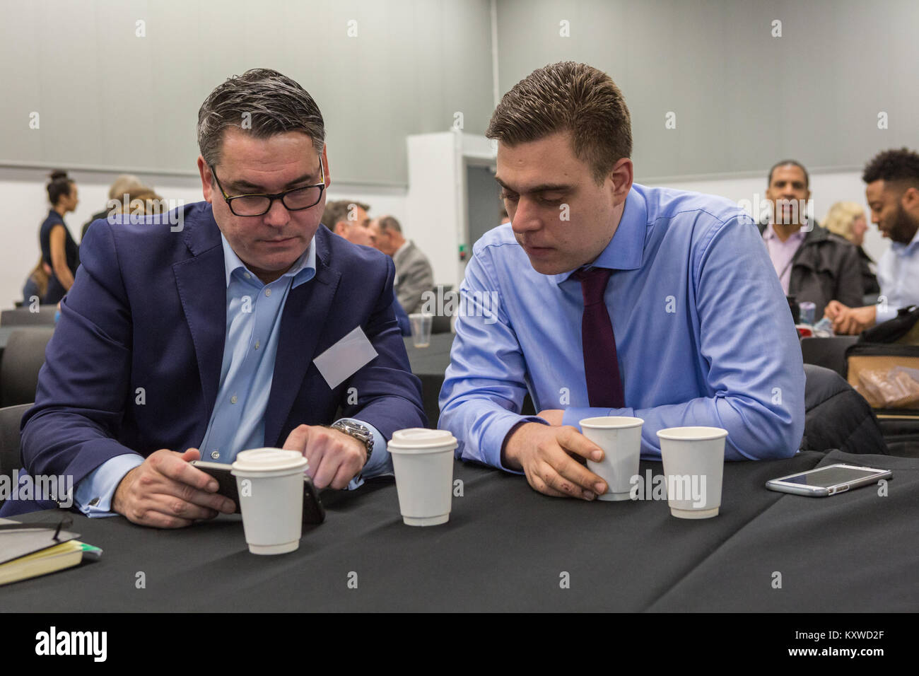 Two businessmen networking in seminar Stock Photo - Alamy