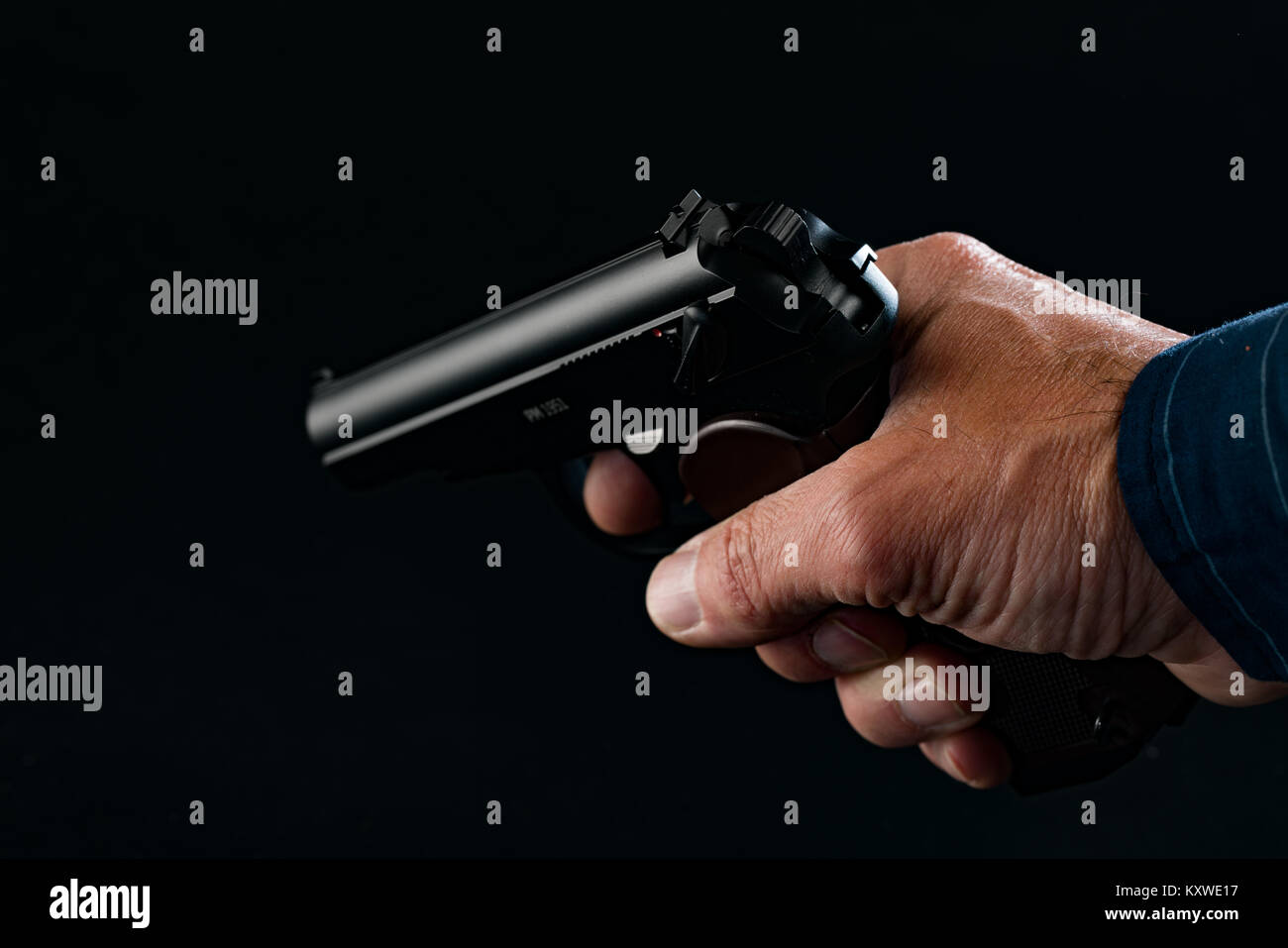 Male hand with gun Stock Photo - Alamy