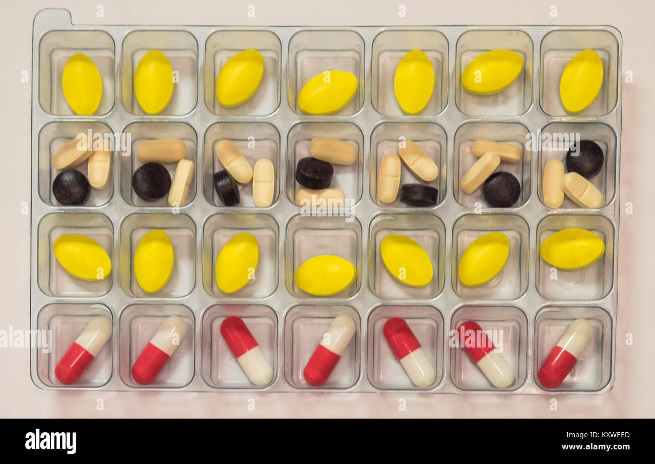 Drugs vitamins and pills on a horizontal pillbox Stock Photo - Alamy