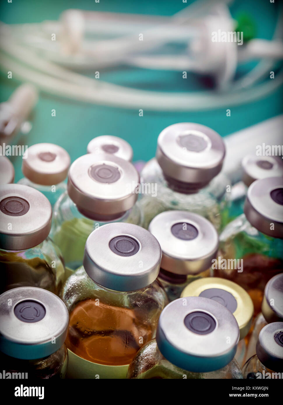 Vials of different size next to syringes at a hospital table ...