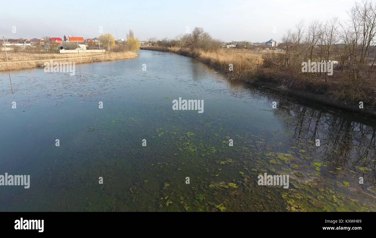 River eric current in the village in the spring. Shallow river, slowly ...