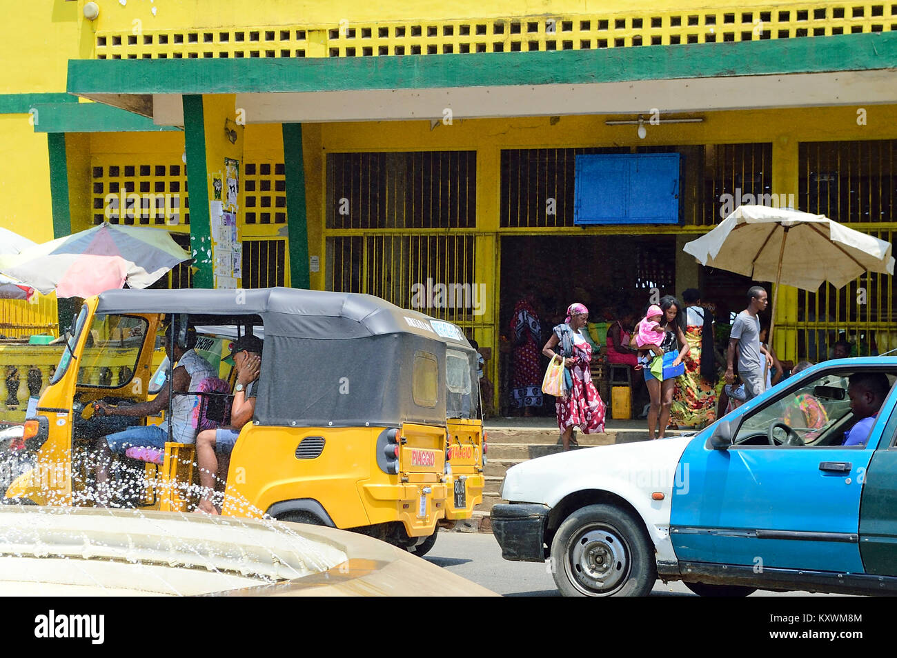 Traditional taxi customers in the city traffic at Hell Ville, Nosy Be ...