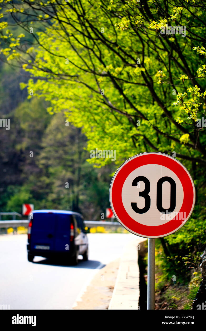 Speed limit sign in the high mountain road. The focus point is on the ...