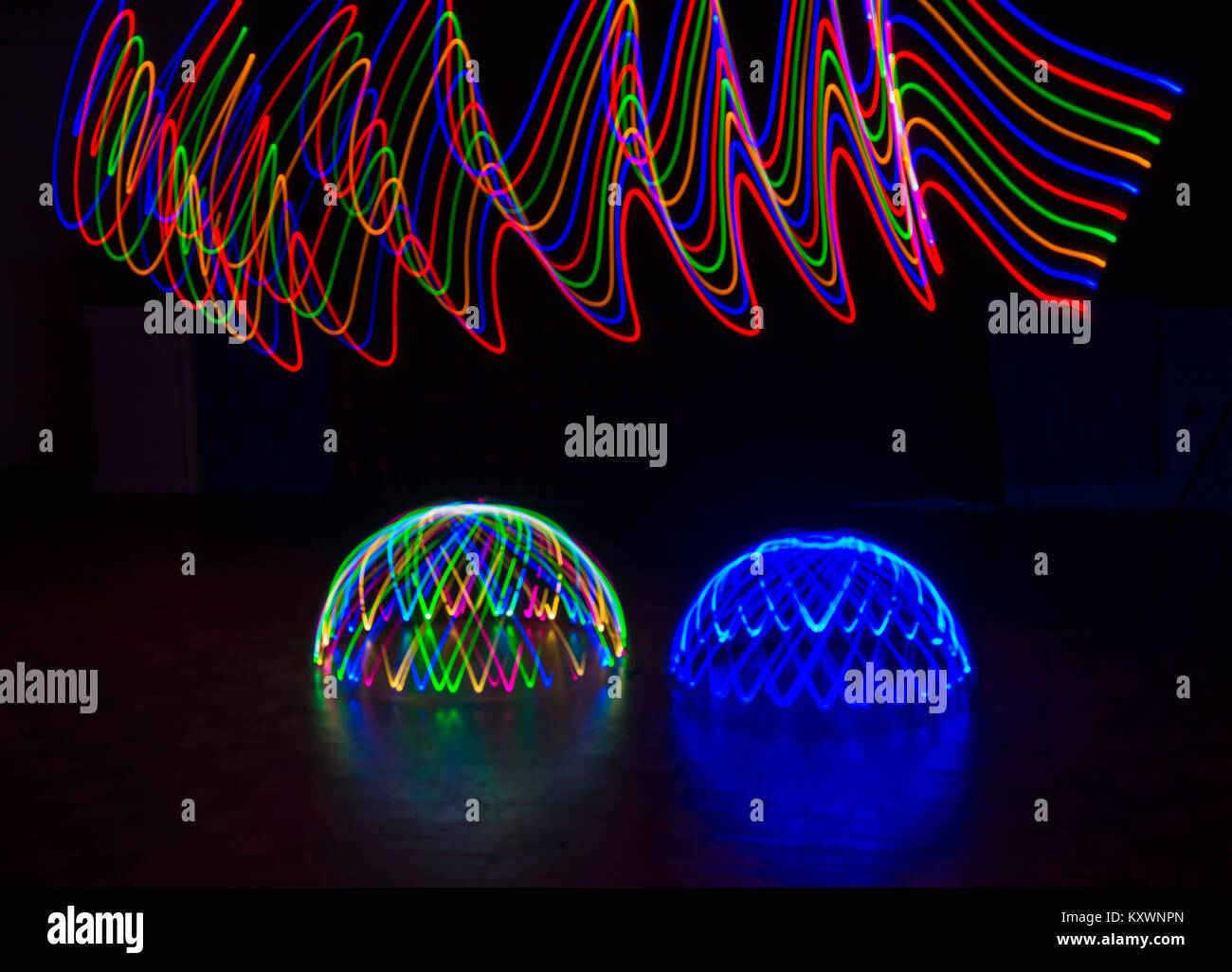 multi-coloured light trails patterns in waves above multi-coloured ...