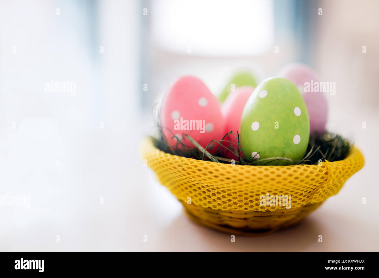 Easter basket filled with colorful eggs Stock Photo - Alamy