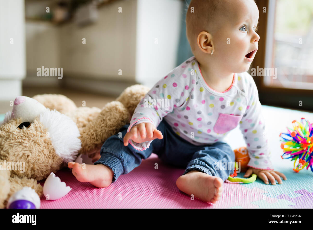 Baby toddler playing color toys at home or nursery Stock Photo - Alamy