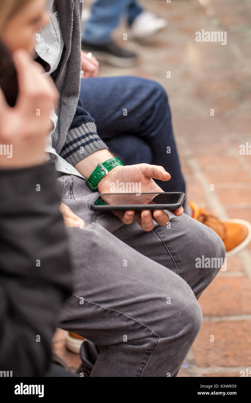 Close up of people using smartphones, focus on hands holding phone ...