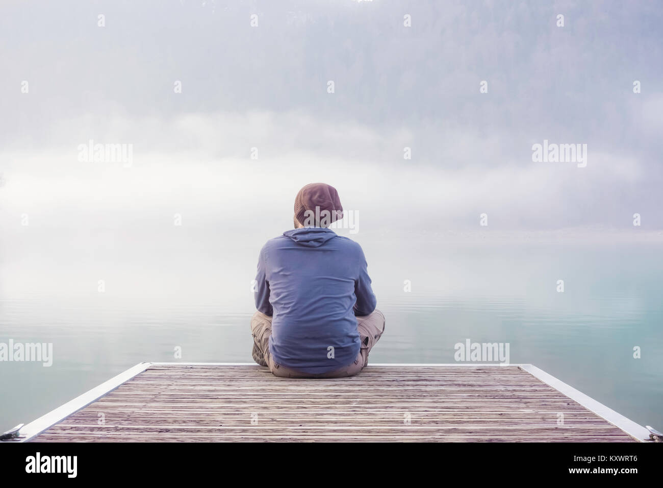 Man sitting on dock hi-res stock photography and images - Alamy