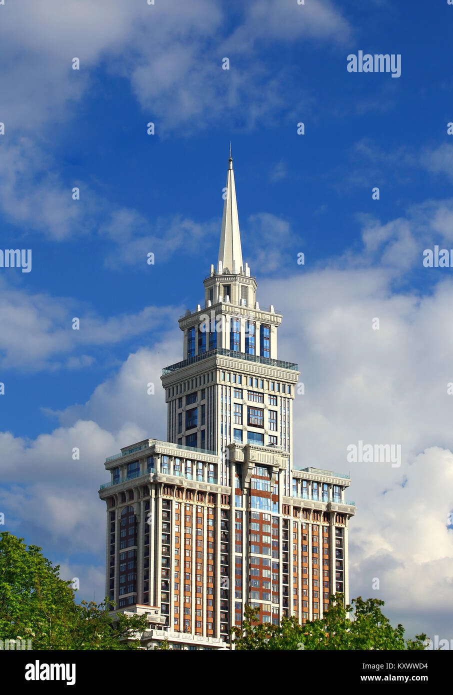 Top of the huge residential building with white spire Stock Photo - Alamy