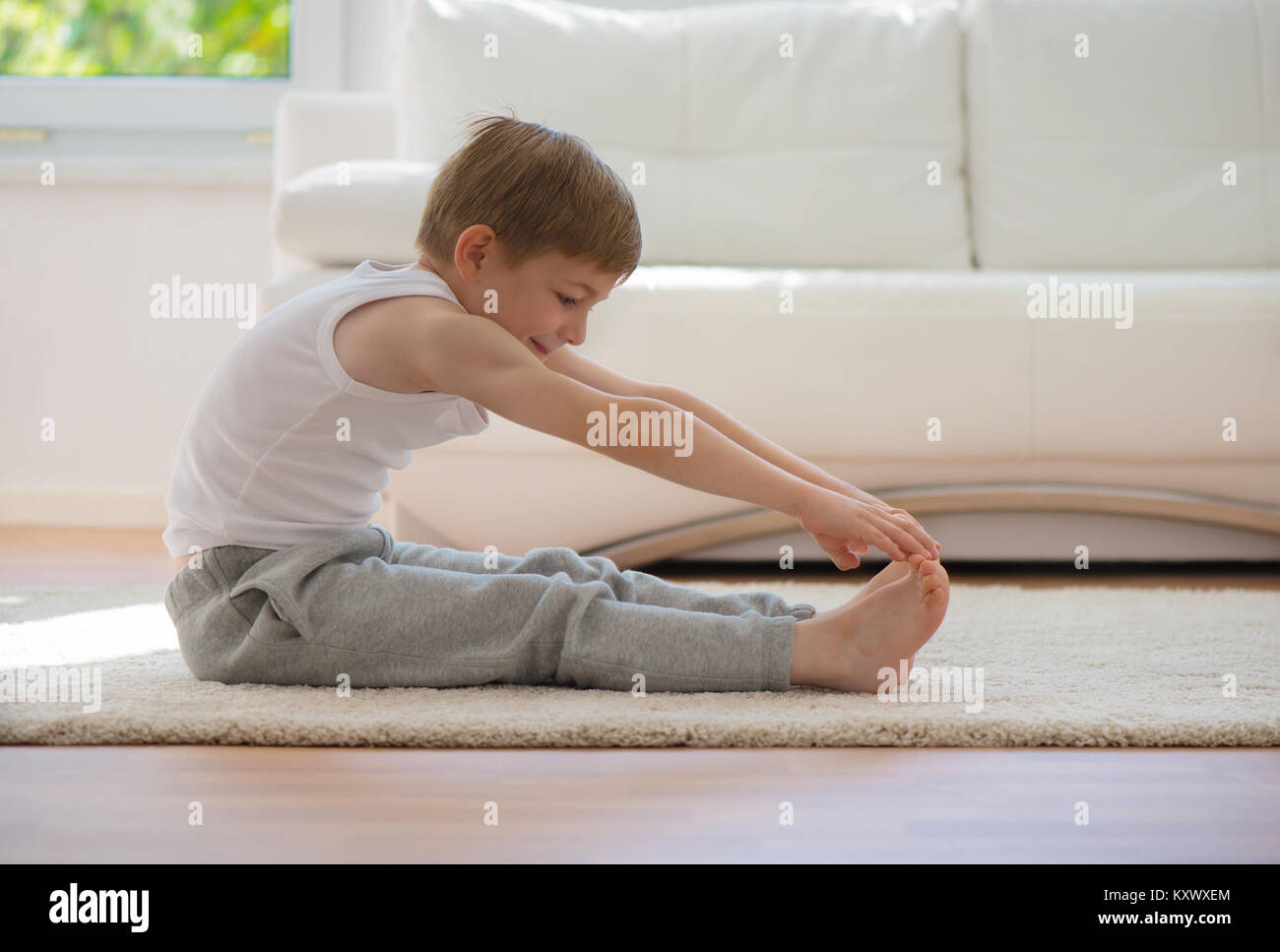 Happy little boy exercising sport at home Stock Photo - Alamy