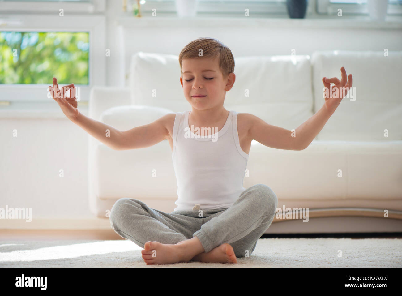 Happy little boy exercising sport at home Stock Photo - Alamy