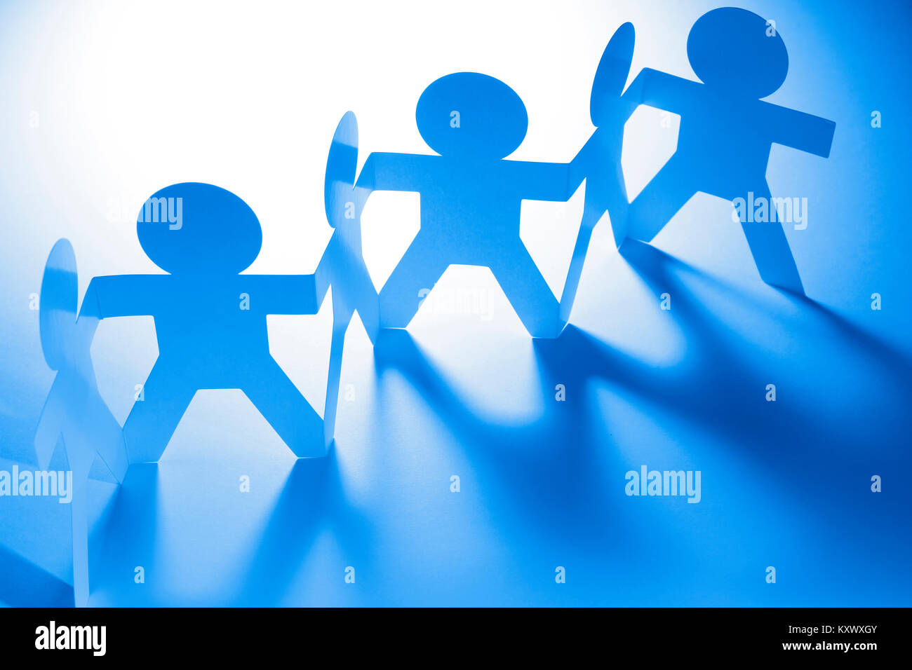 Team of paper chain people Stock Photo - Alamy