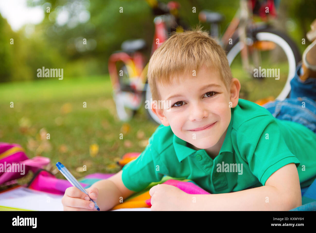 Portrait of one cute boy, he draws in park Stock Photo - Alamy