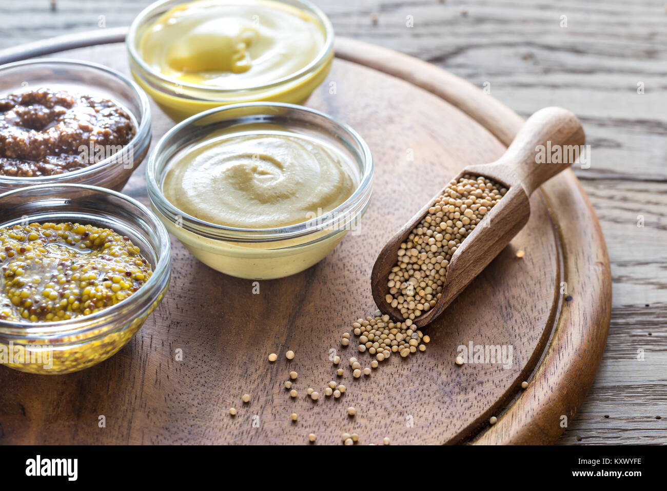 Different kinds of mustard on the wooden background Stock Photo - Alamy
