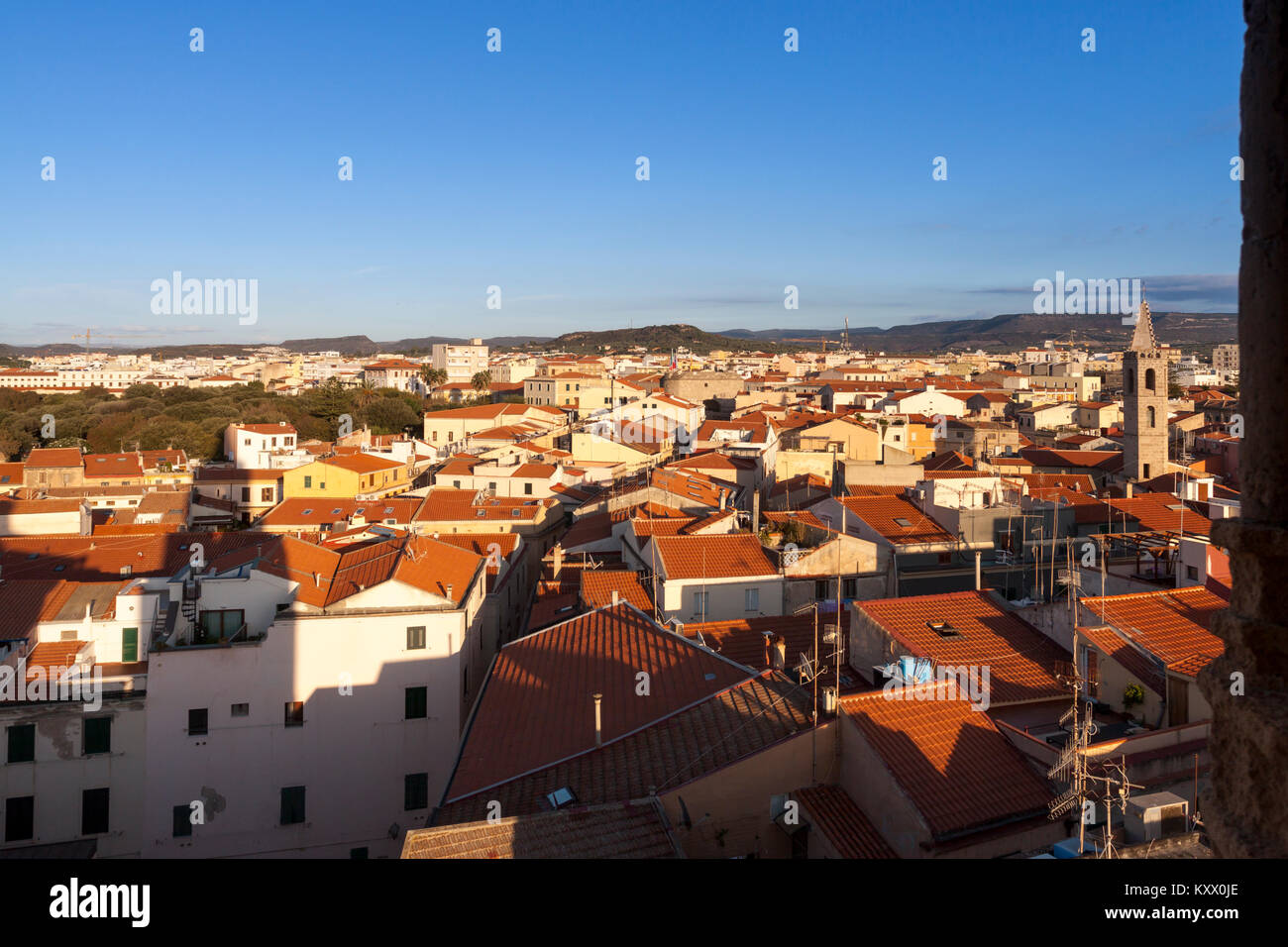 Aerial view of city against romantic skyline at sunset. Alghero ...