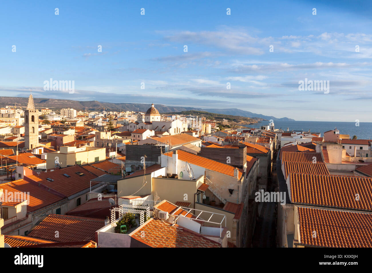 Aerial view of city against romantic skyline at sunset. Alghero ...