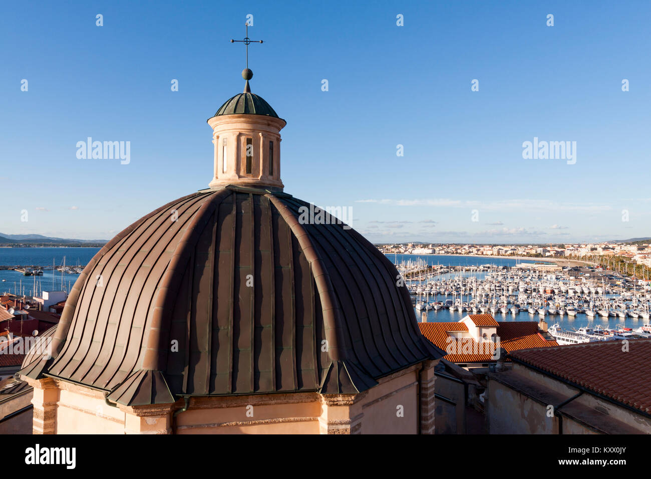 Aerial view of city against romantic skyline at sunset. Alghero ...