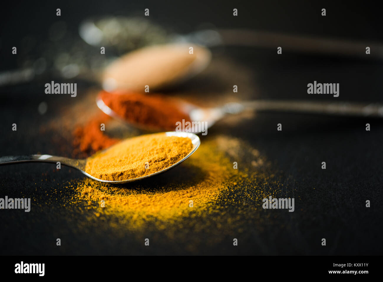 close up of various spices and herbs scattered in metal spoon Stock ...