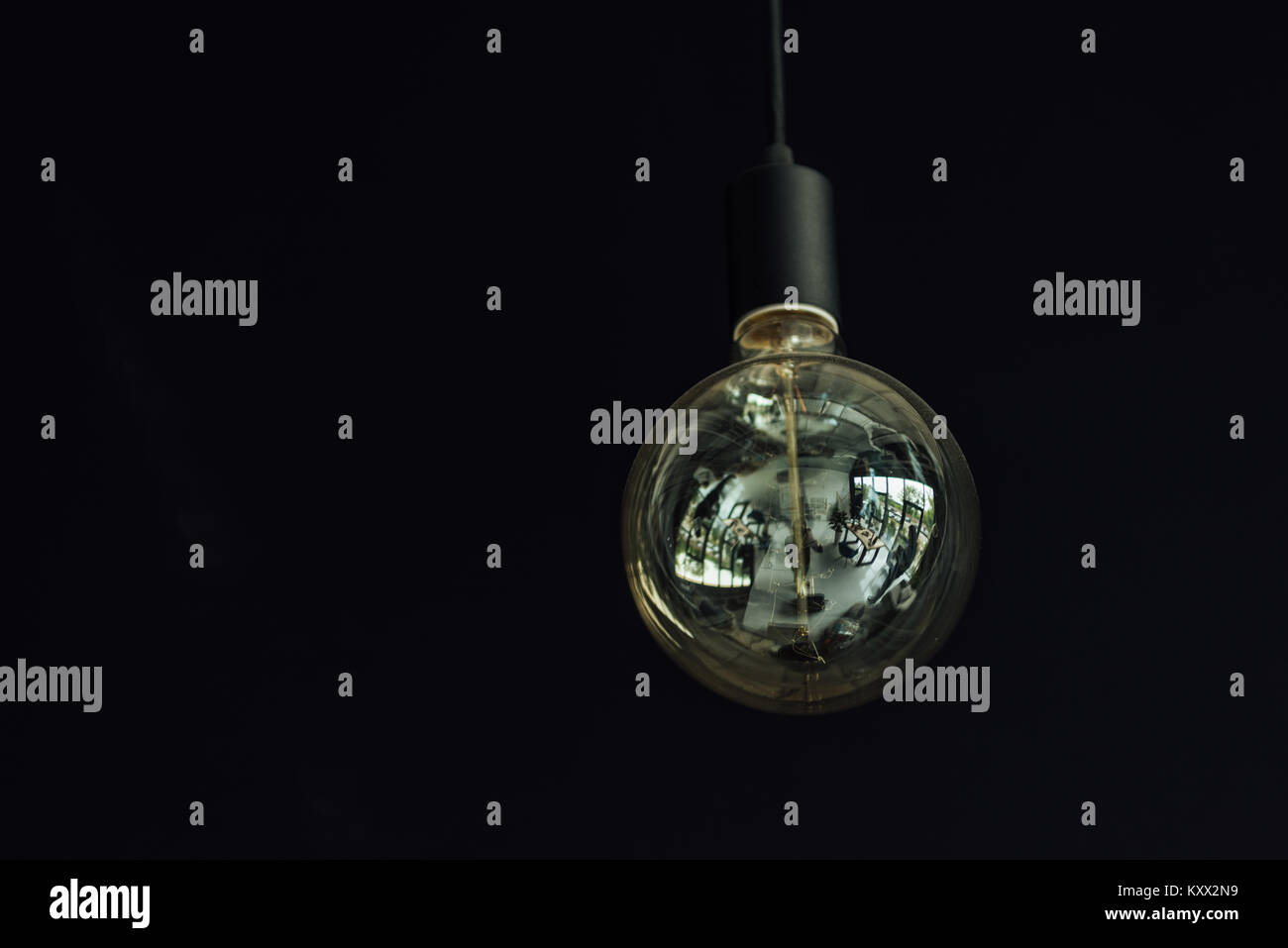 Vintage hanging Edison light bulb on black background Stock Photo - Alamy