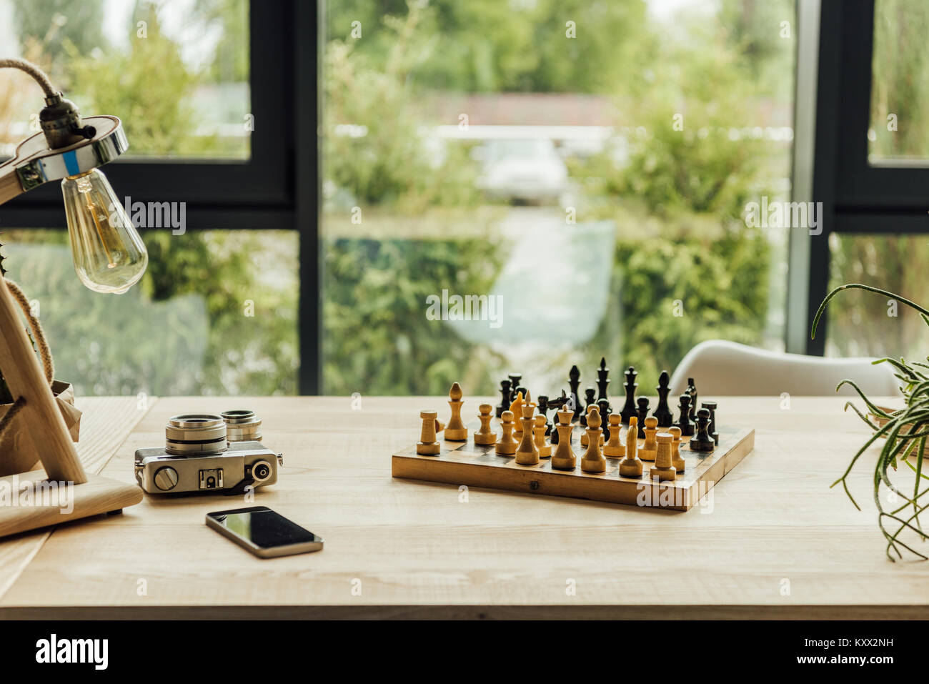 Chess board, vintage camera and smartphone lying wooden table Stock ...
