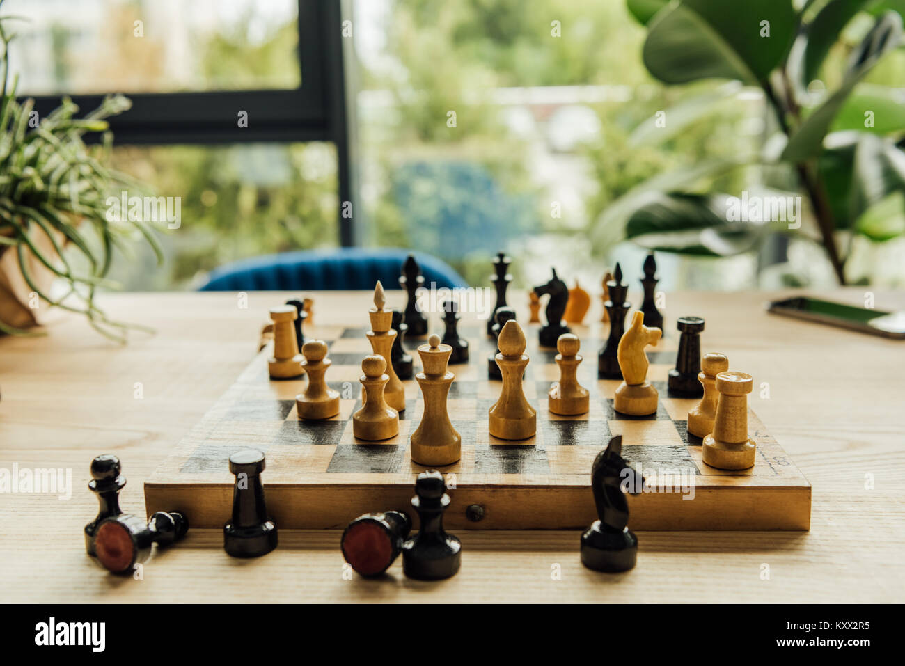 Side view of black and white chess pieces on chessboard during the game ...