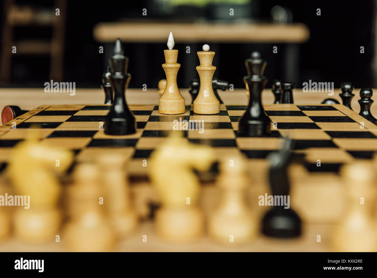 Side view of black and white chess pieces on chessboard during the game ...