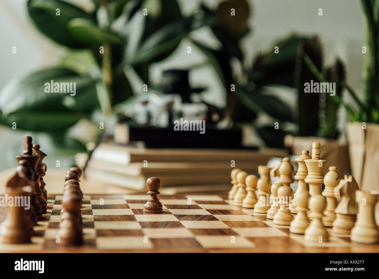 Side view of black and white chess pieces on chess board ready to start ...