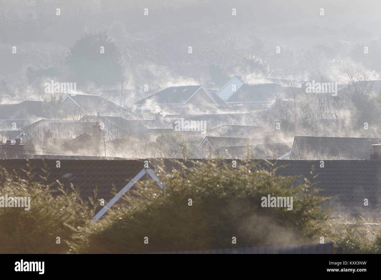 steam rising off wet rooves on foggy day in the uk Stock Photo - Alamy