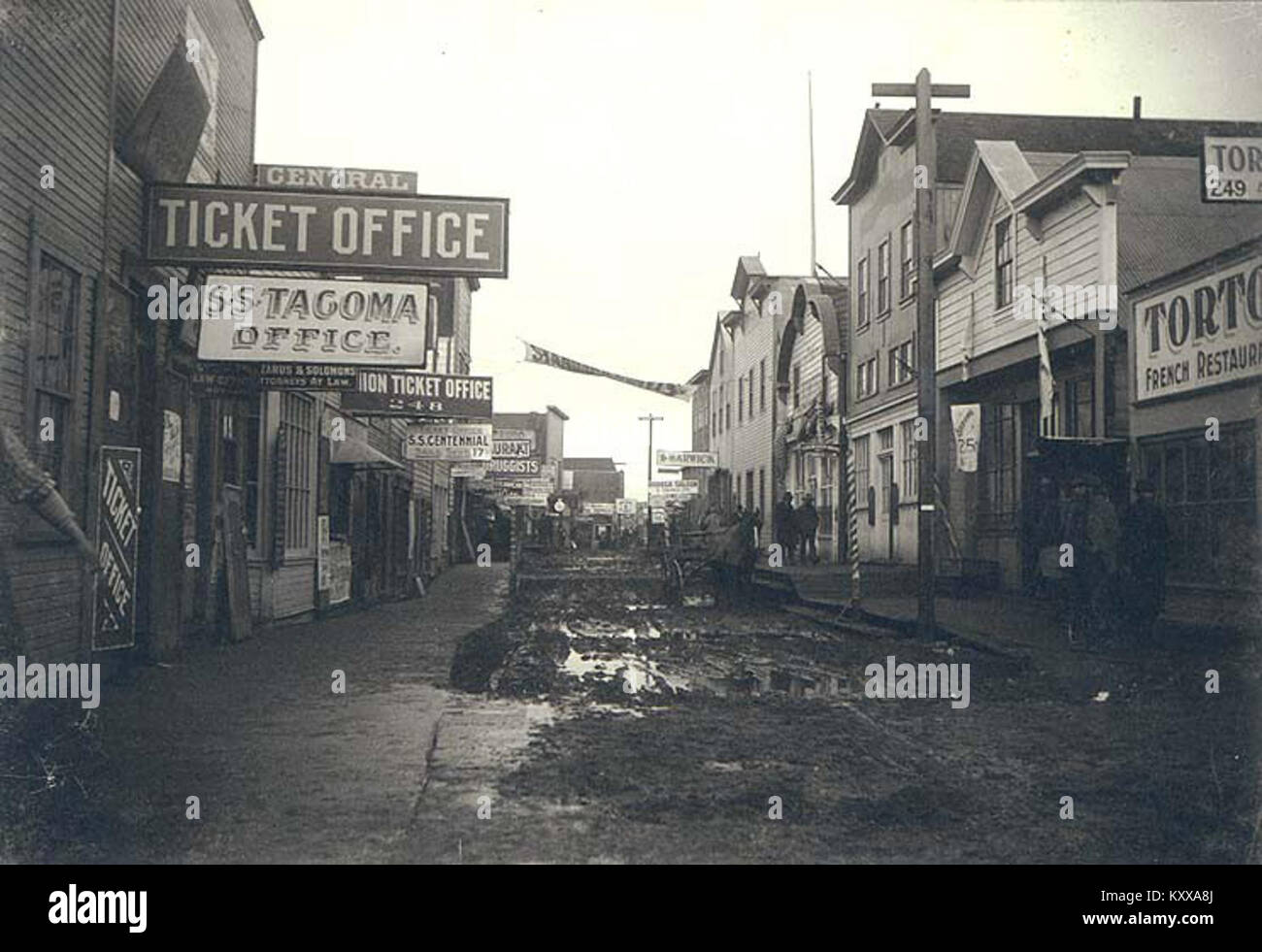 A historical photograph of Front Street in Nome, Alaska, taken around ...