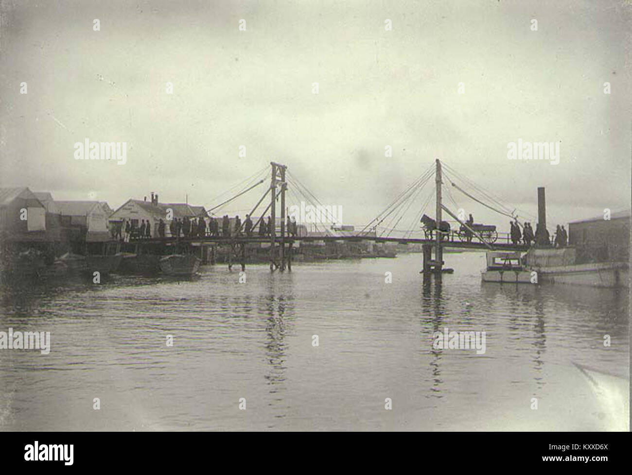 This early 20th-century image captures a funeral procession crossing a ...
