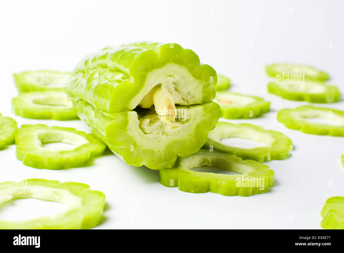 Sliced bitter melon gourd on white background Stock Photo - Alamy