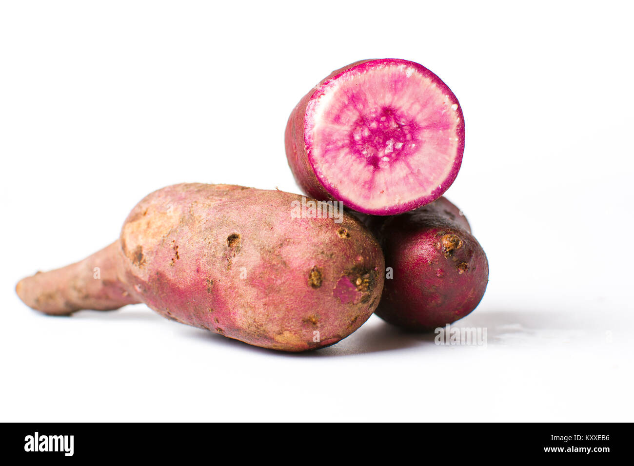 Raw purple sweet potato isolated on white background Stock Photo - Alamy