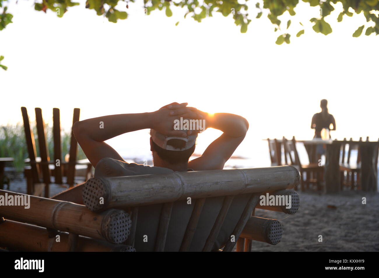 Relaxing in a bar by the sea under the shade of a almond tree, Costa ...