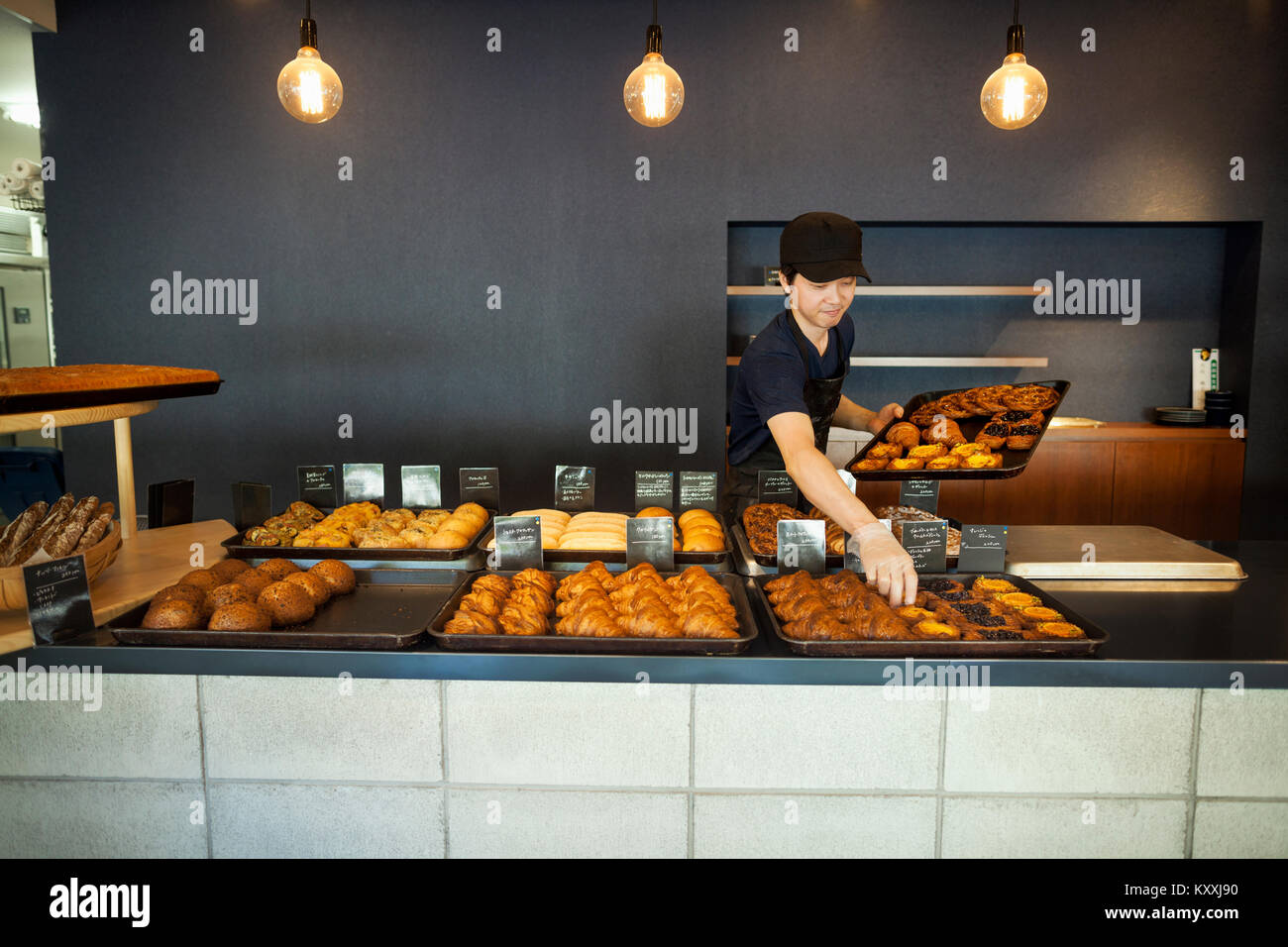 Baker placing cakes in hi-res stock photography and images - Alamy