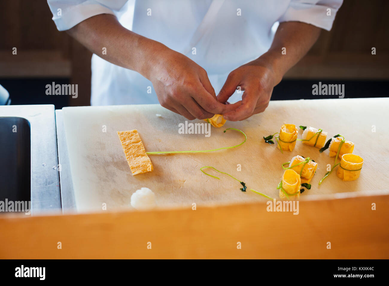 High angle close up of chef working at a counter at a Japanese sushi ...
