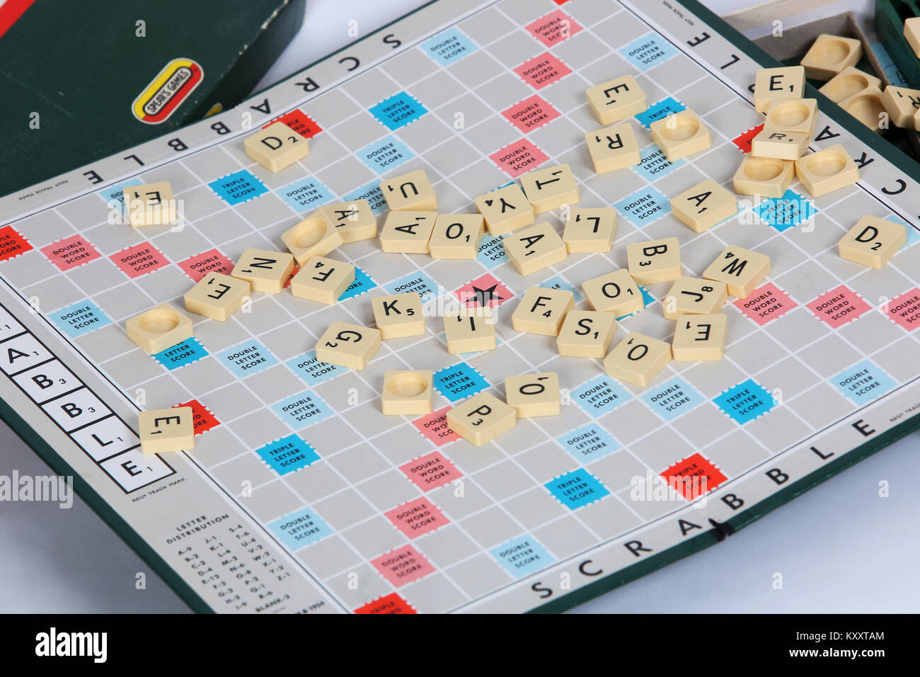 An old Scrabble game pictured shot on a white background in a studio in ...