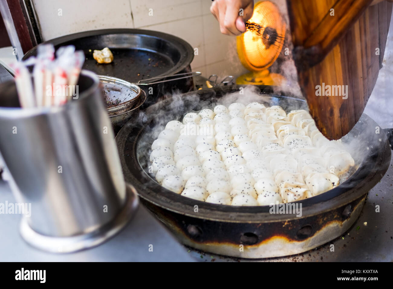 Sheng Jian Bao and Guo Tie being cooked - Shanghai pan fried dumplings ...