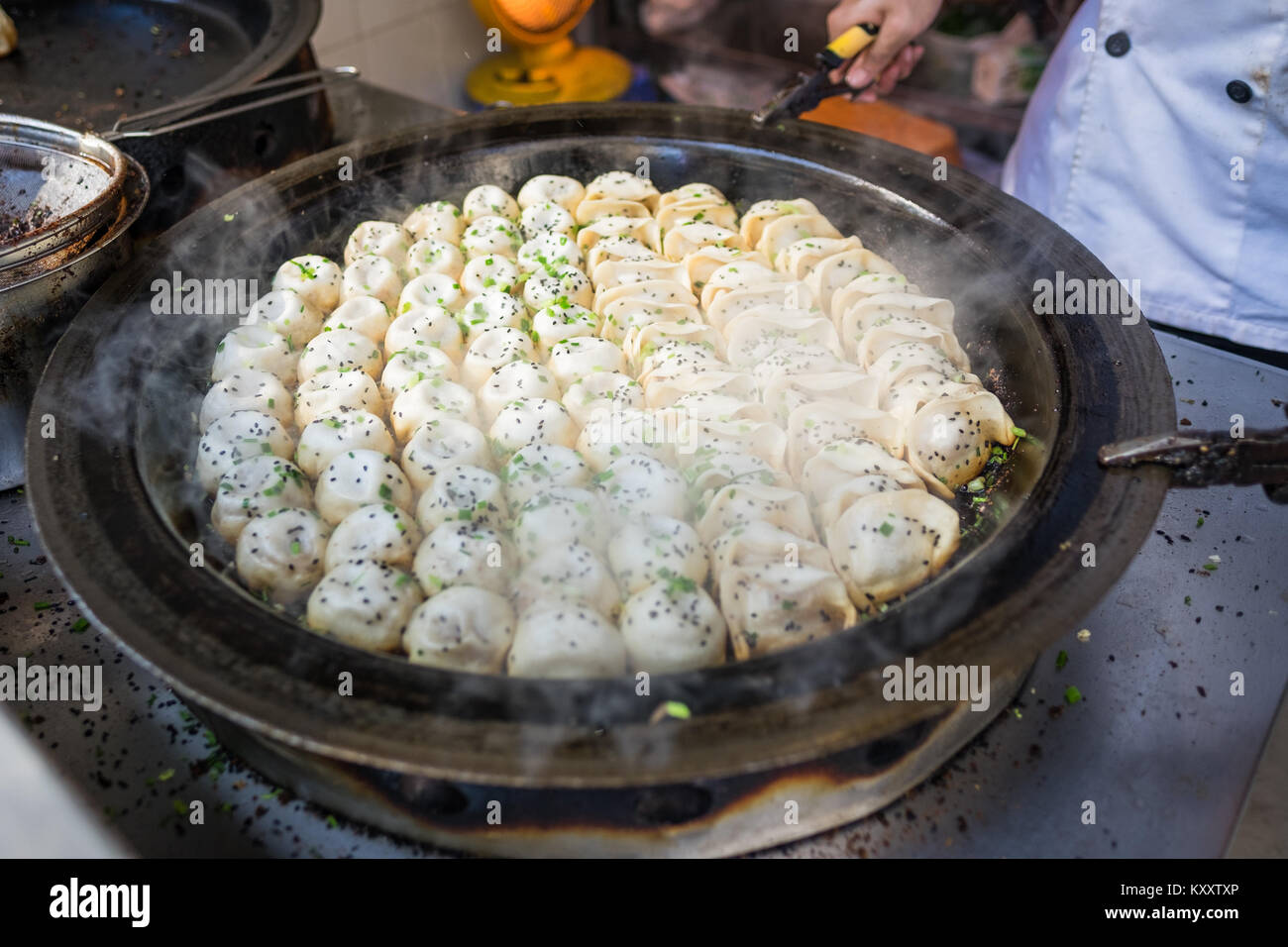 Sheng Jian Bao and Guo Tie being cooked - Shanghai pan fried dumplings ...