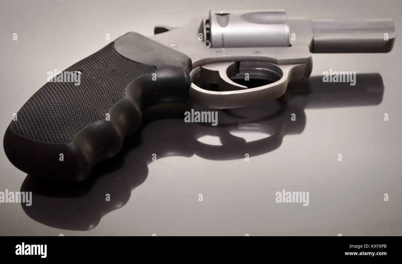 A 44spl stainless steel revolver with a black handle laying upon a ...