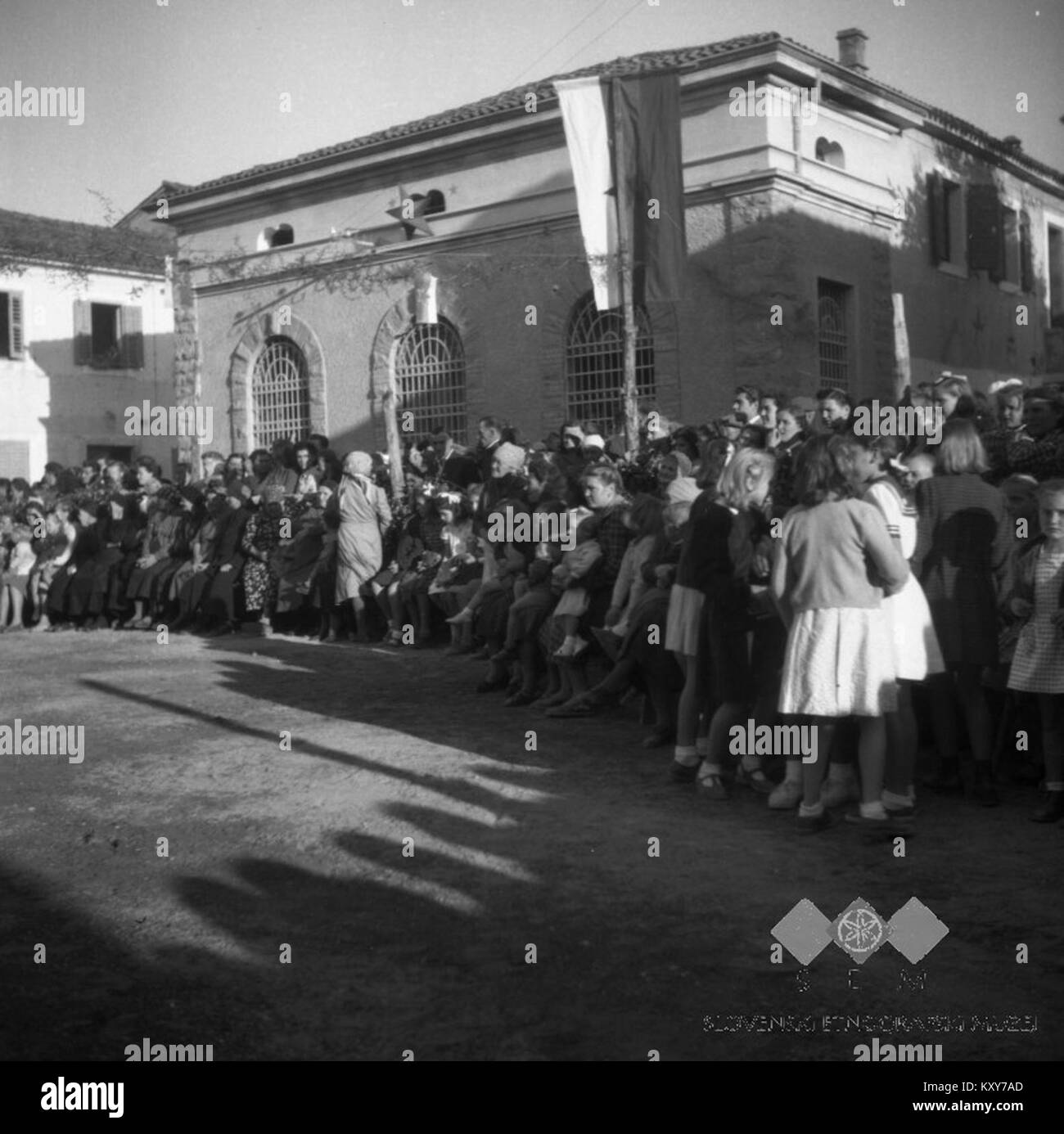 A historical image taken in 1949 showing a crowd watching a street ...