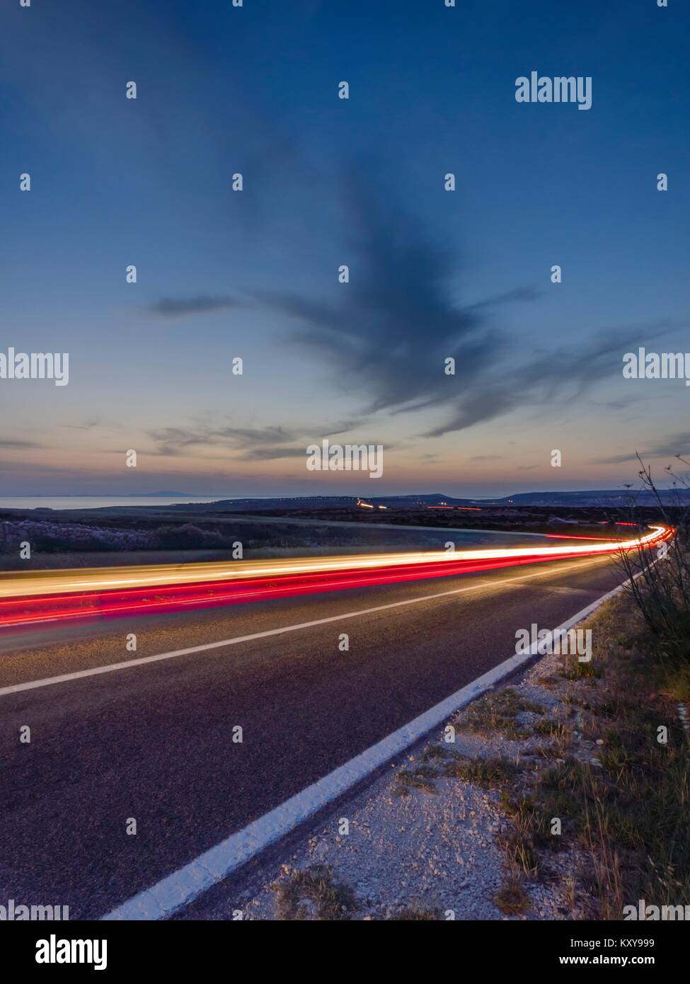 Light trails on country-road country-side in evening dusk time after ...