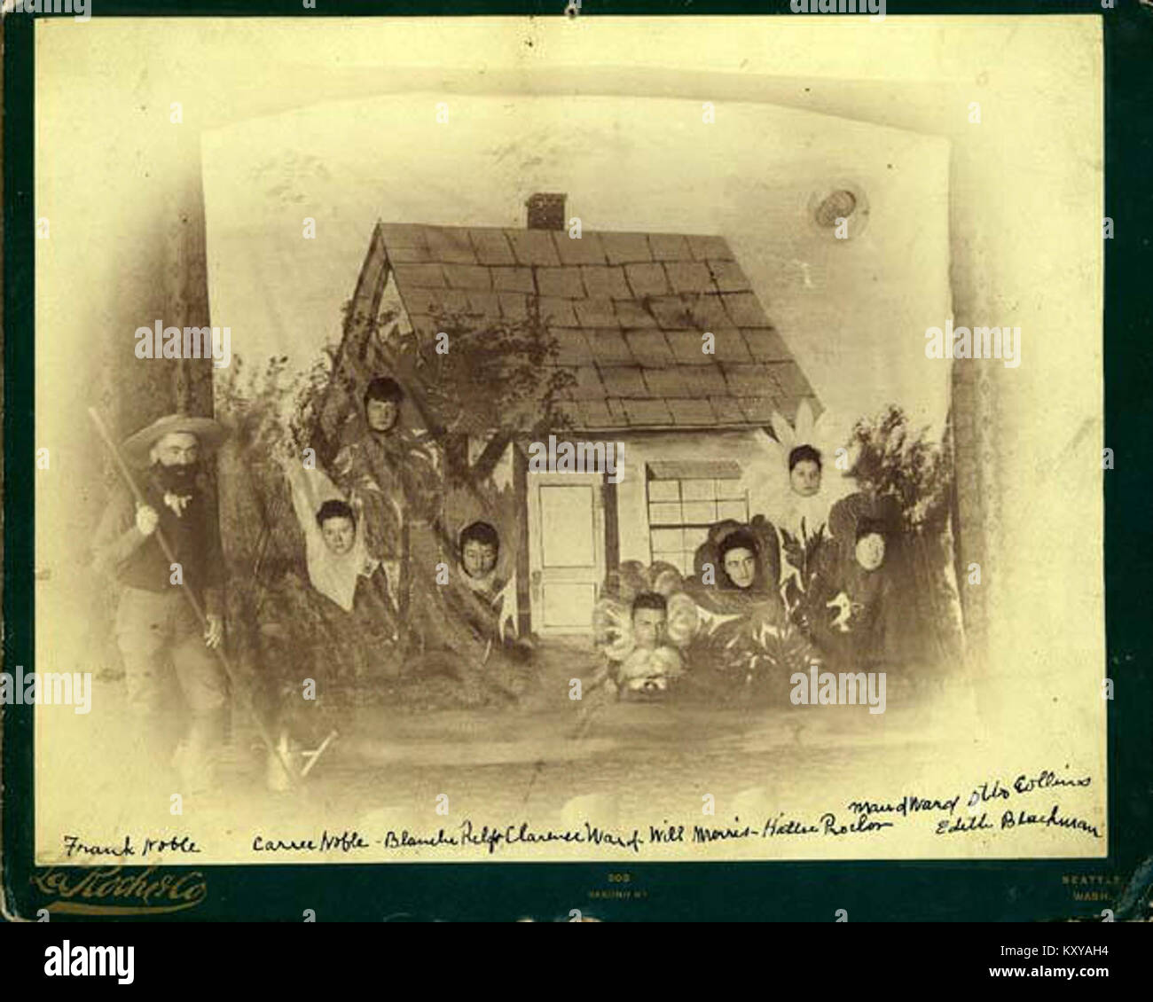 Group portrait of nine individuals with studio prop, probably Seattle ...